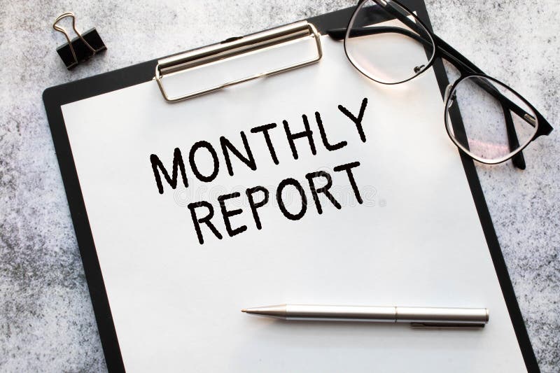 MONTHLY REPORT Text Written on a Paper Clipboard with Chart and ...