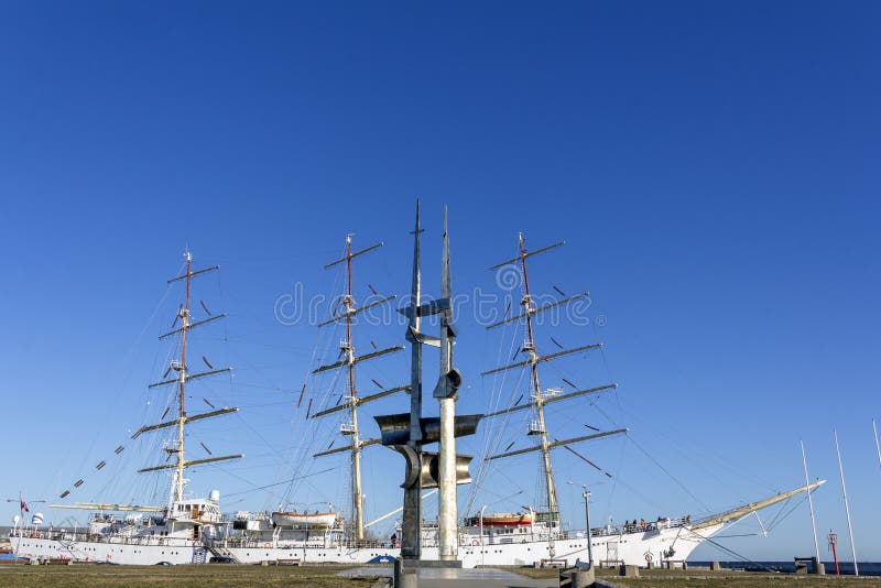 A Monument in Front of a Large Sailing Ship Stock Photo - Image of ...