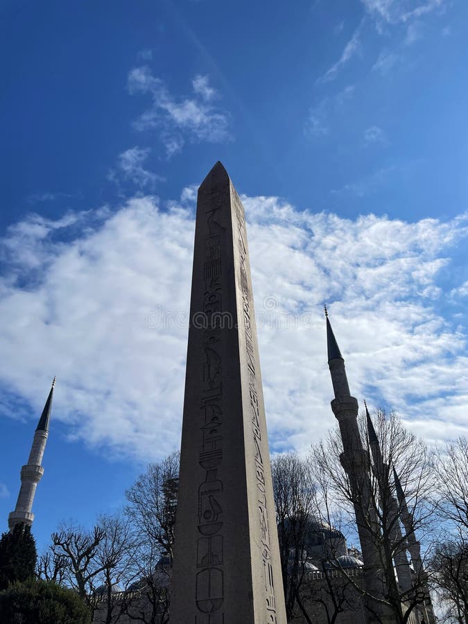Tall Egyptian Obelisk Featuring Engraved Inscriptions Against a Partly ...