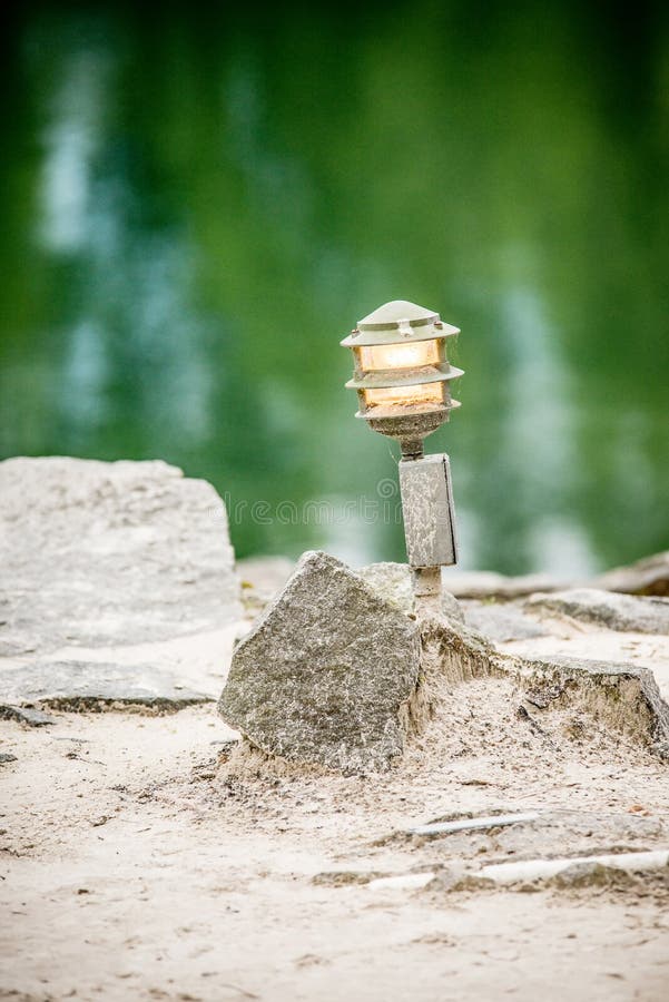 Mood Lighting Light Fixture on Rocks by Water Stock Image - Image of ...