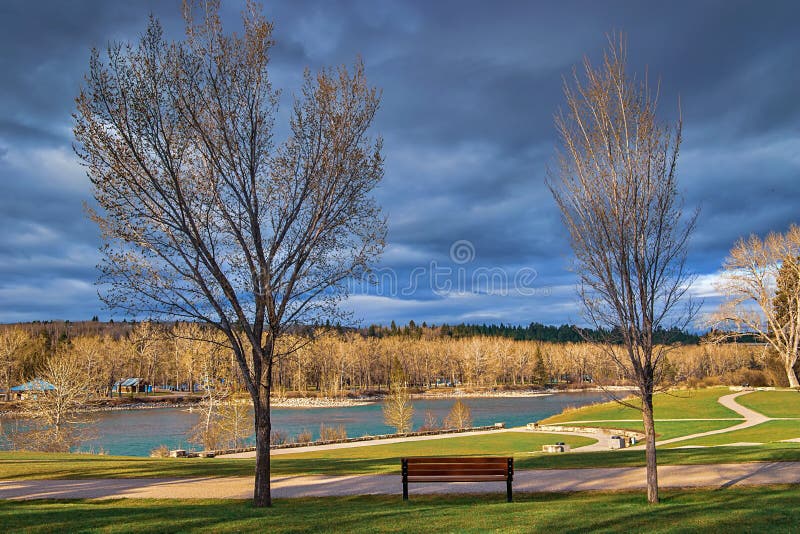 Moody Clouds Over a Spring Park Stock Photo - Image of trees, river ...