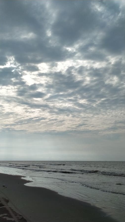 Moody Cloudy Sky Over Calm Sea Waves at the Beach Stock Image - Image ...