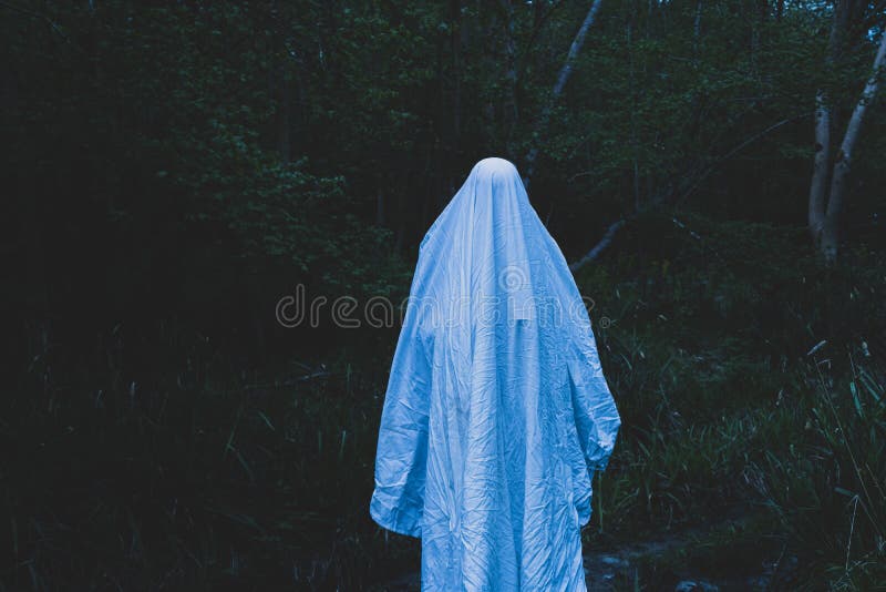 A Moody Horror Edit of a Ghost with a Sheet Over it`s Head. Standing in ...
