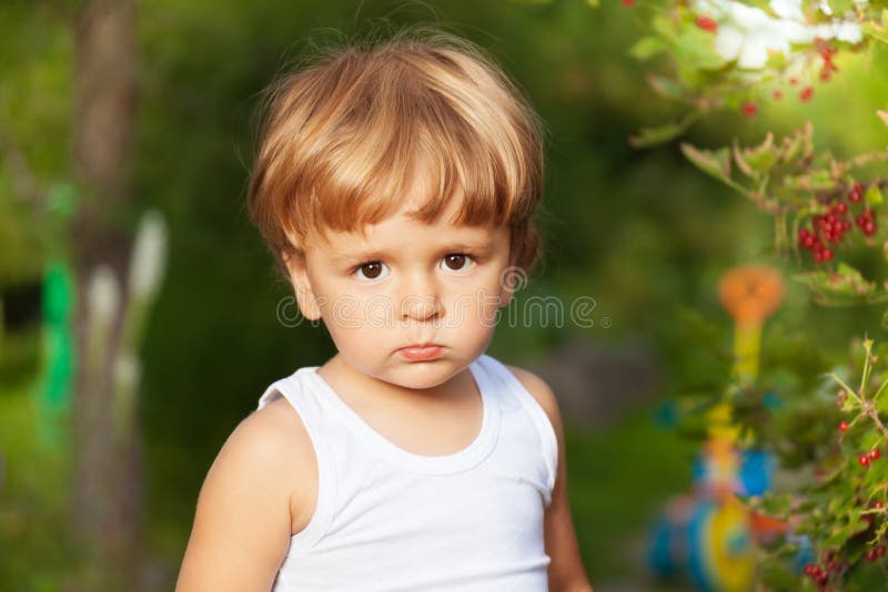 Moody kid in the garden stock photo. Image of cute, funny - 26319360