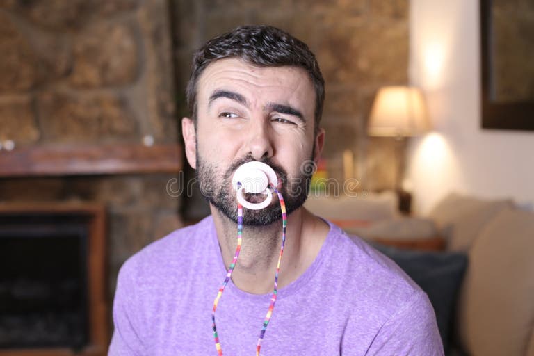Moody man using a pacifier stock image. Image of male - 217113771