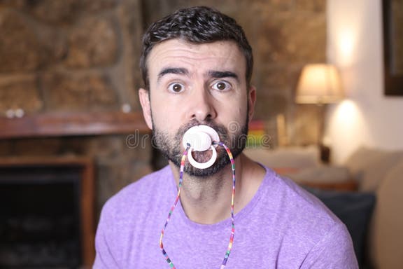 Moody man using a pacifier stock photo. Image of lifestyle - 217113776
