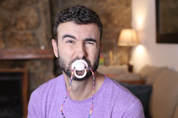 Moody man using a pacifier stock image. Image of mouth - 217113783