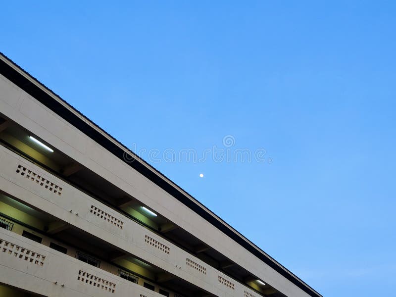Moon from Behind the Building. Stock Image - Image of noon, moon: 153099795