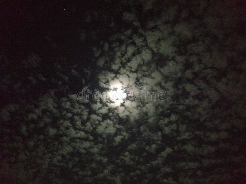 Moon behind eerie clouds stock photo. Image of clouds - 128027964