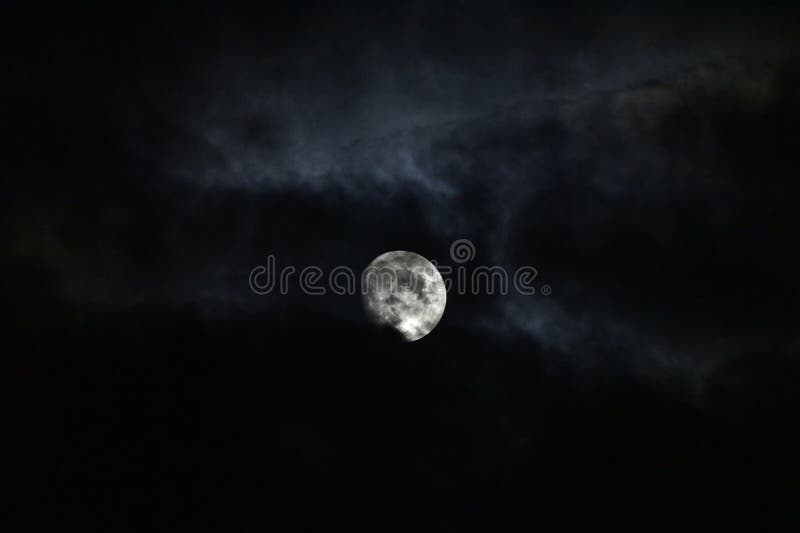 The Moon Breaking through the Clouds in the Night Sky. Stock Image ...