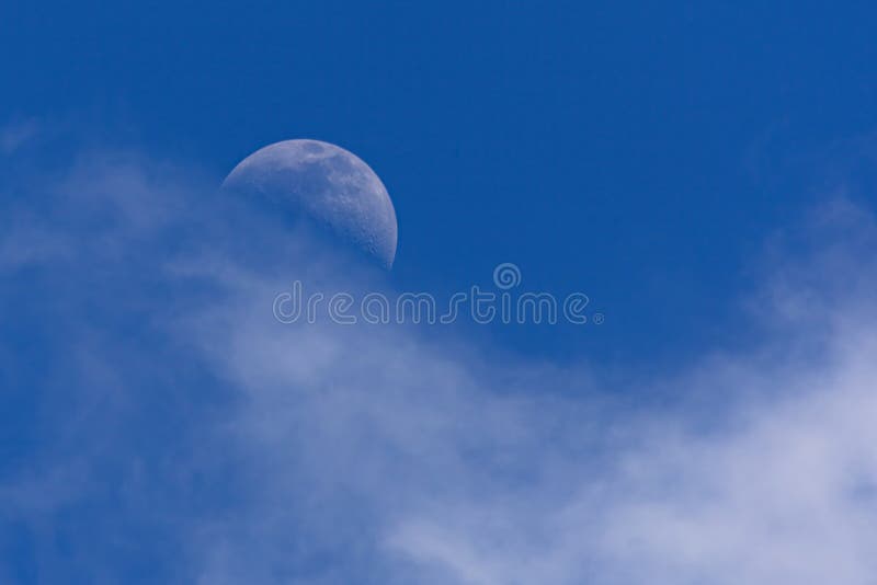 Moon in Broad Daylight, Half Hidden Behind a Cloud Stock Image - Image ...