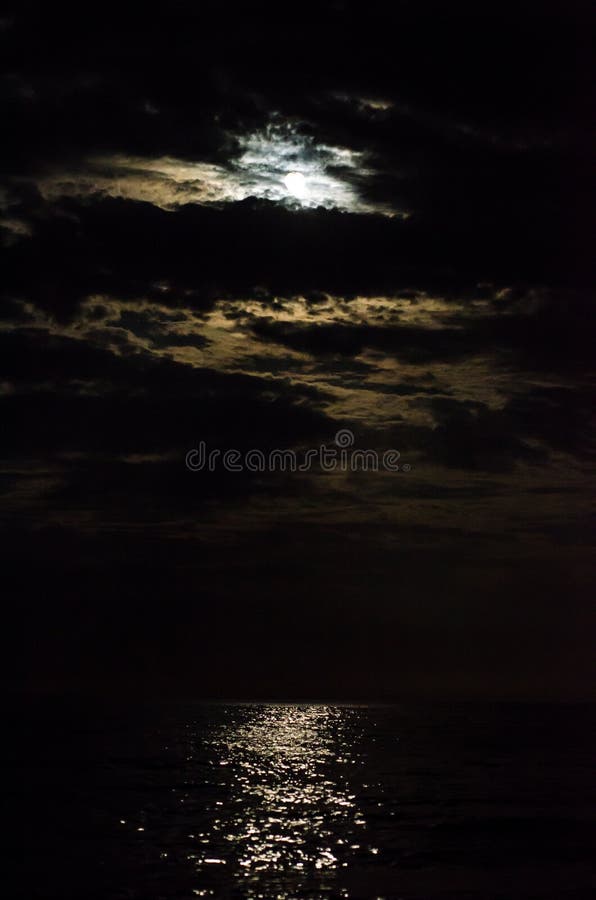 Moon covered with clouds stock photo. Image of dark, ocean - 33063022
