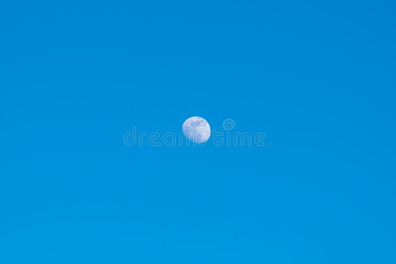 Moon during the Day, Against a Flawless Beautiful Blue Sky, Close-up ...