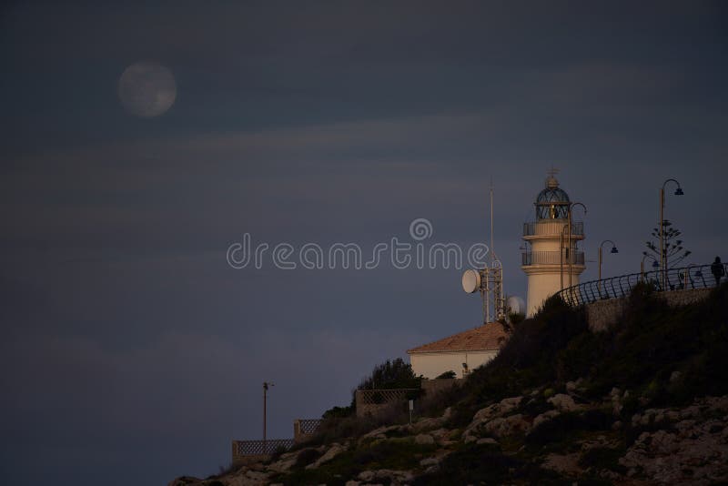 Moon Eclipse Over a Lighthouse on the Coast Stock Image - Image of ...