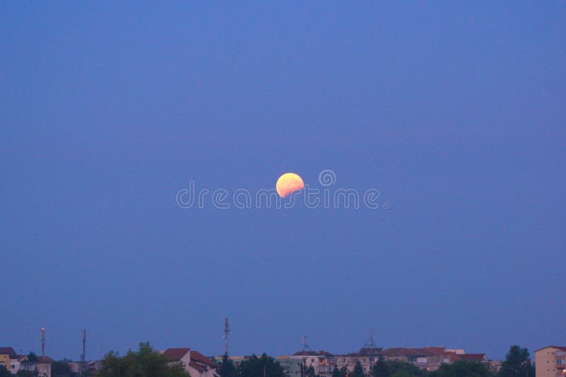 Moon eclipse over the town stock photo. Image of presentation - 229063122