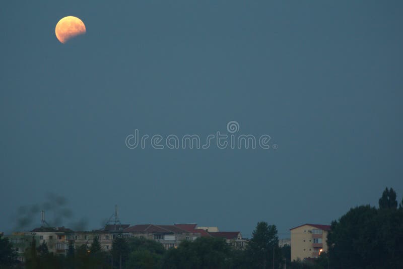 Moon eclipse over the town stock photo. Image of cloud - 229063124