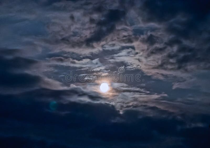 The Moon Looks through an Opening in the Clouds Stock Image - Image of ...