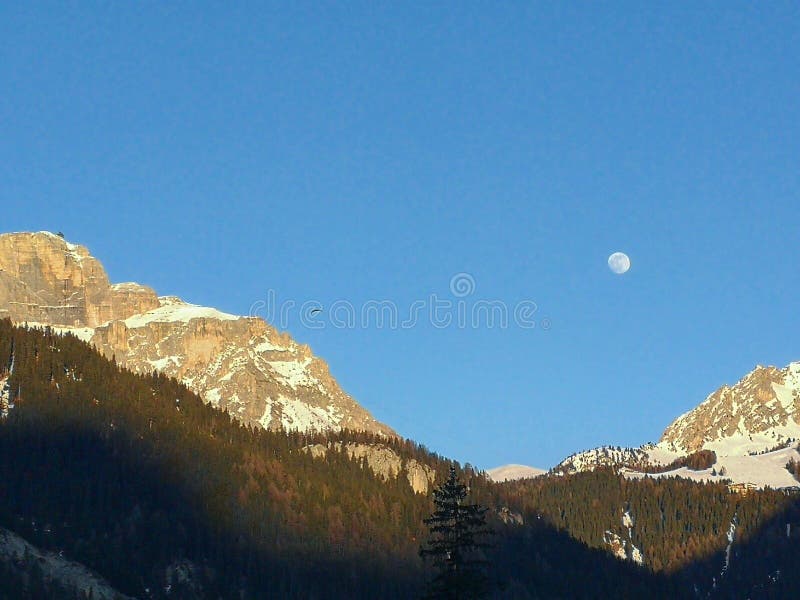 Moon between the mountains stock image. Image of reflection - 208573431