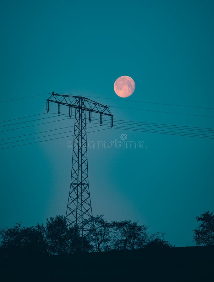 The Moon in the Night Sky Against the Background of Power Lines Stock ...