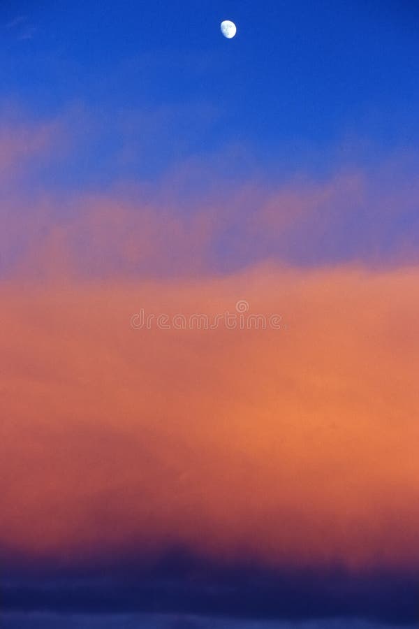 Moon on orange clouds stock image. Image of orange, sunset - 1795143
