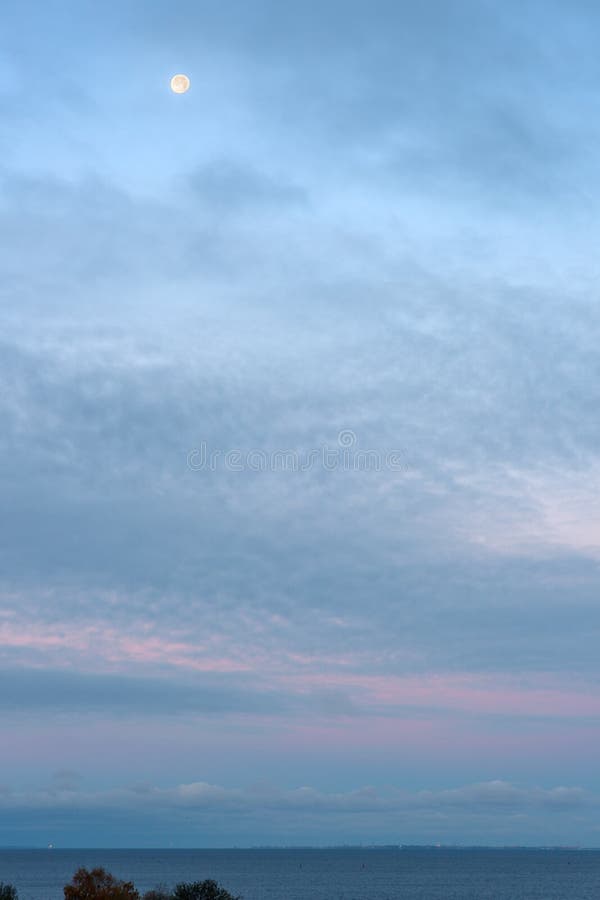Moon over the bay stock photo. Image of horizon, dawn - 256006576