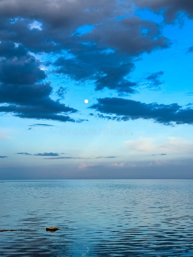 Moon Over the Lake. Full Moon in the Clouds. Kyrgyzstan, Lake Issyk-Kul ...