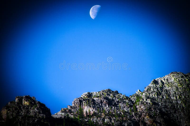 Moon over Mountain Peaks stock image. Image of mountain - 125455343
