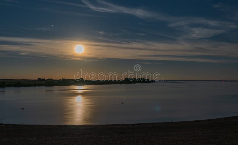 The Moon Over the River in the Starry Sky in Light Clouds. Night Summer ...