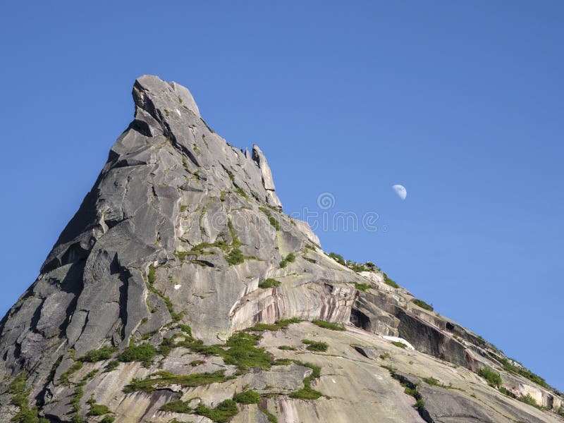 Moon over the sharp rock stock image. Image of people - 315001545