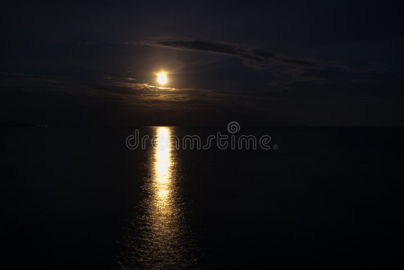 Moon reflection over water stock photo. Image of atmosphere - 144599170