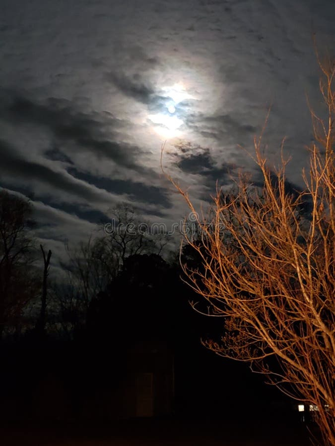 Moon Shining through Clouds Stock Photo - Image of shining, moon: 138405176
