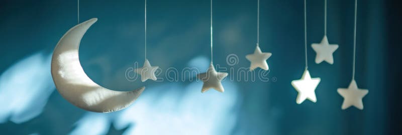 Hanging Mobile Featuring Moon and Stars Casting Soft Shadows in a ...