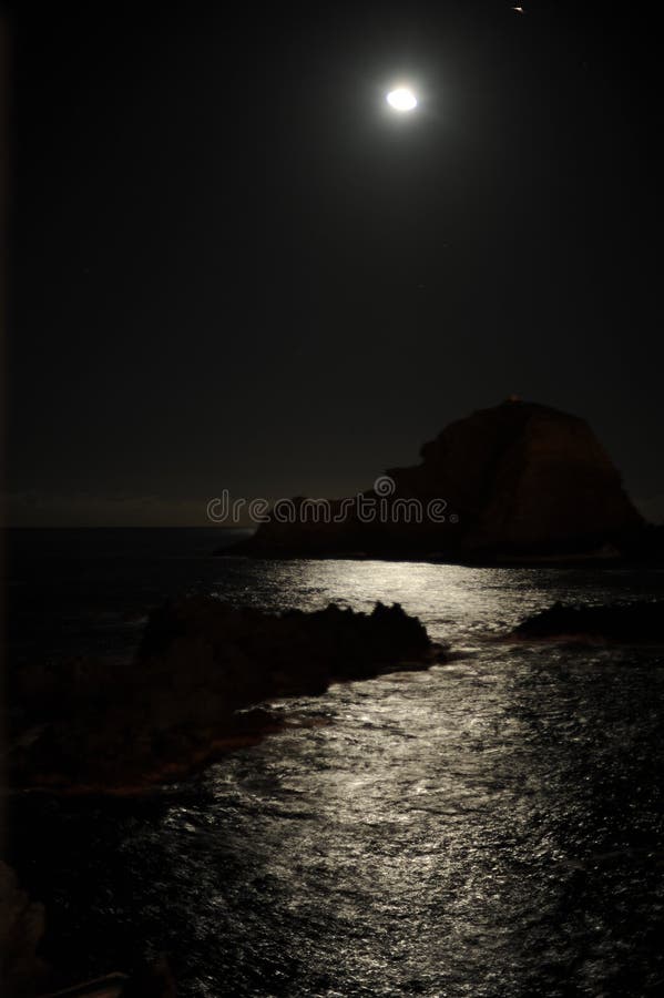 Moonlight of Full Moon Over the Sea at Night with a Rock in the ...
