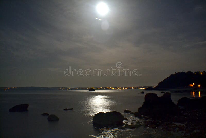Moonlight Over Midnight Shore Stock Photo - Image of rocks, moonlight ...