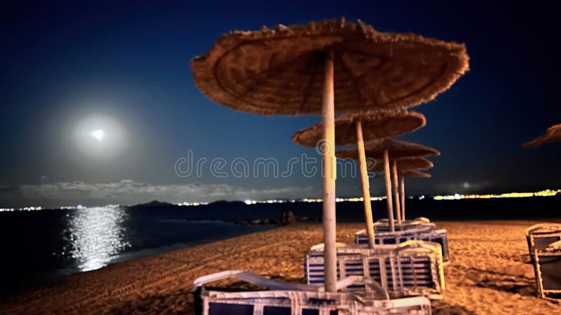 Moonlight Shining on the Seaside with Huts and Chairs at the Sandy ...