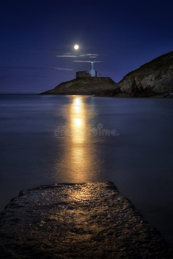 Moonlit Mumbles Lighthouse stock photo. Image of coast - 99384420