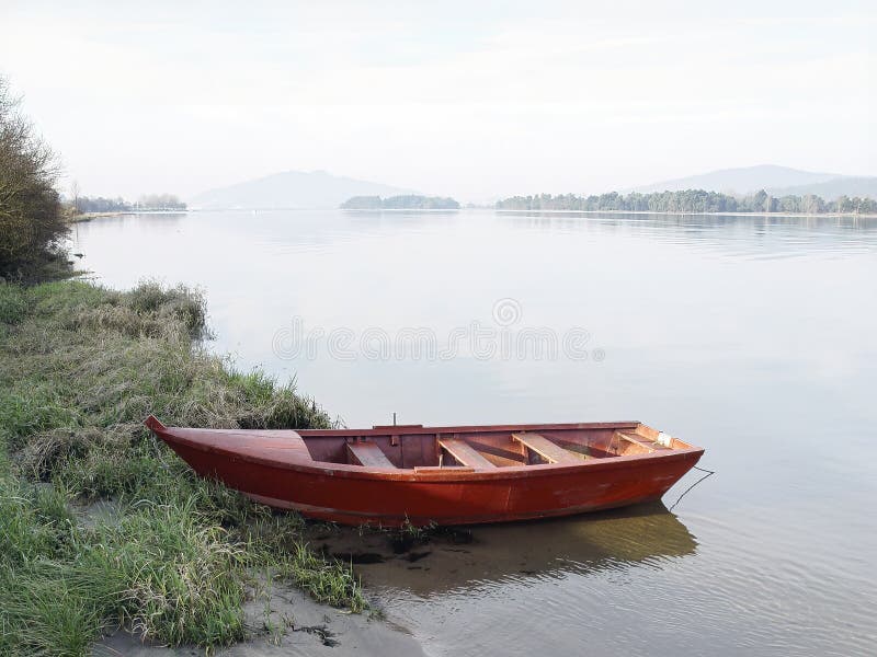 Moored red wooden boat stock photo. Image of coastline - 318087880
