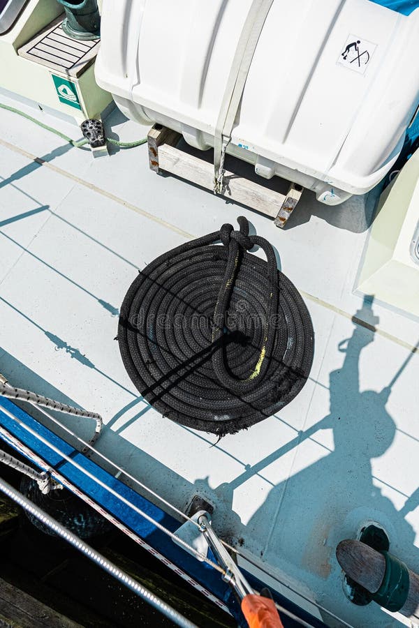 Mooring Line on the White Deck of a Boat Stock Photo - Image of black ...