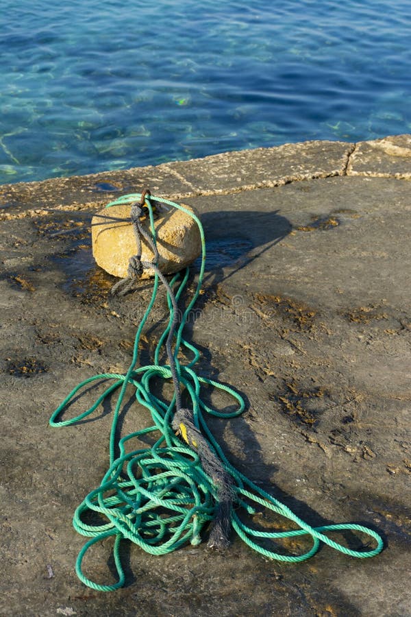 Mooring stone and ropes stock photo. Image of ocean - 266608046