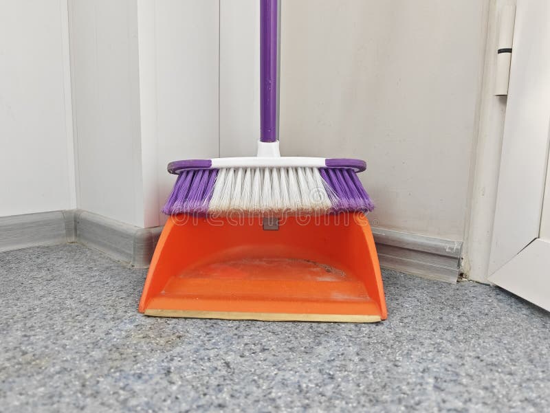 A Mop and a Dustpan for Cleaning the Garbage are in the Corner of the ...