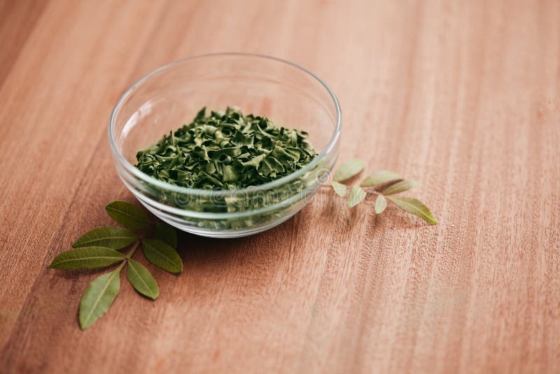 Moringa Leaf Powder in Glass Jar on Wooden Background Stock Image ...