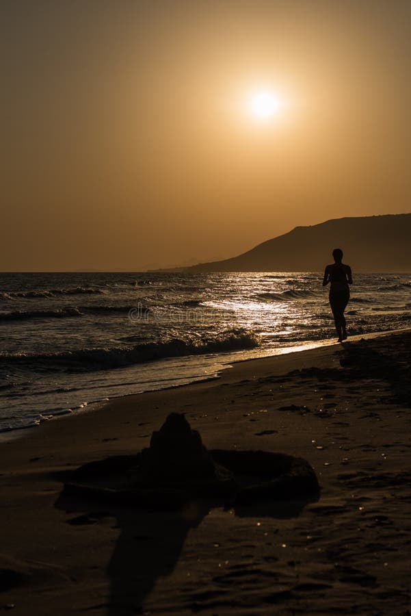 Morning beach and runner stock photo. Image of dark - 137872672