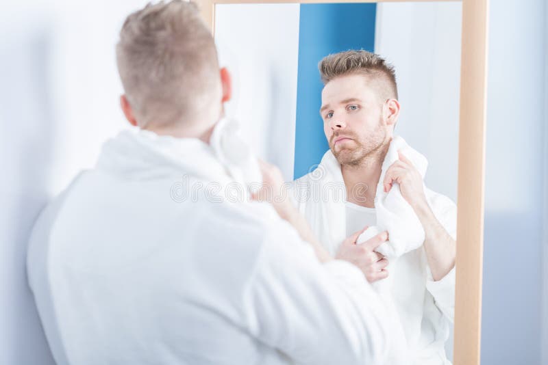 Morning look in the mirror stock image. Image of male - 65307473