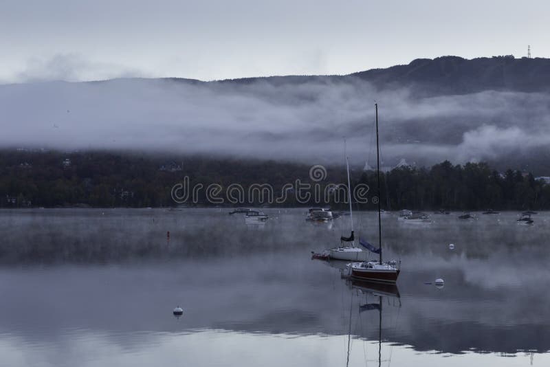 Morning Mist Over a Lake with Boats Stock Photo - Image of early, boats ...