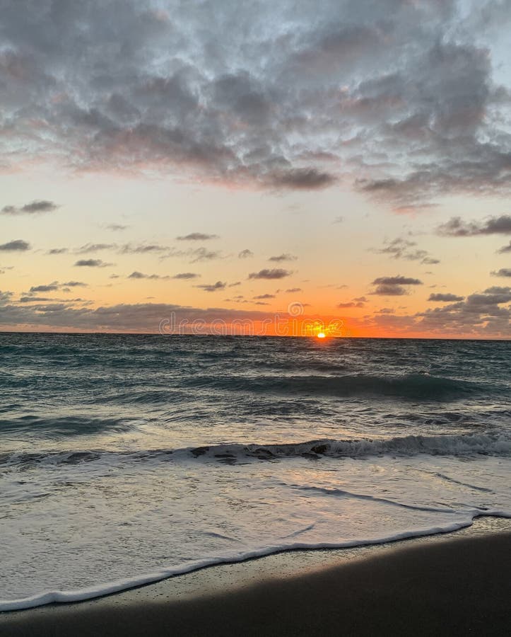 A Morning Ocean Sunrise with Clouds on a Rocky Beach Stock Photo ...