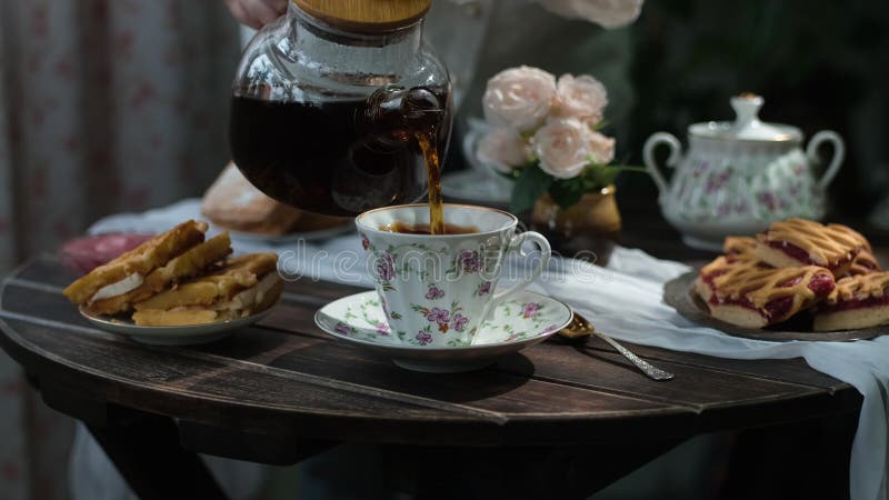 Morning Routine. Female Hands Pouring Tea into Cup during Morning ...