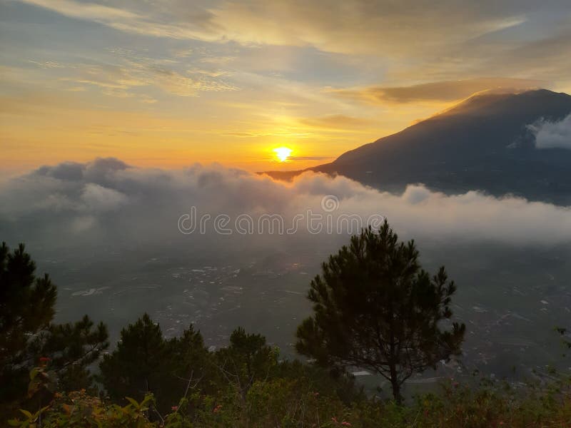 The Morning Sun Appears Behind the Clouds and Mountains with Beautiful ...