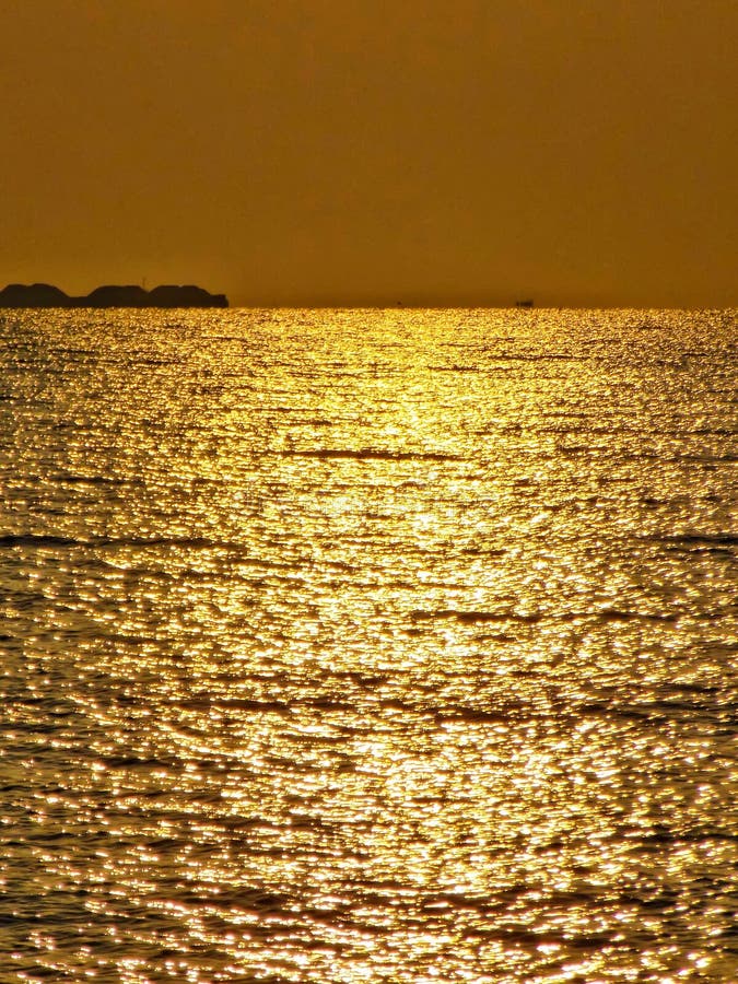 The Morning Sun Reflected on the Beach, Turning Yellow Like Sparkling ...