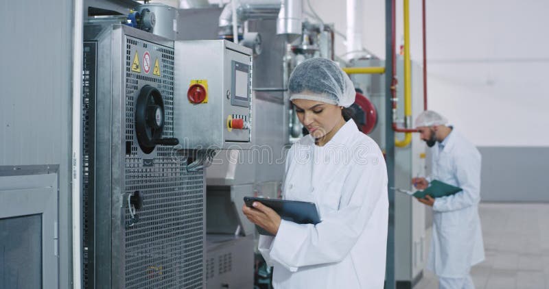 In the Morning Two Beautiful Engineers in Manufacturing Industry Check ...