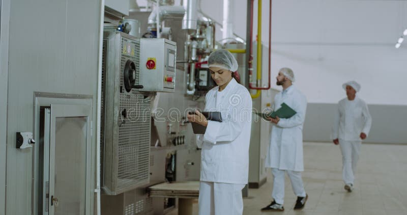 In the Morning Two Beautiful Engineers in Manufacturing Industry Check ...